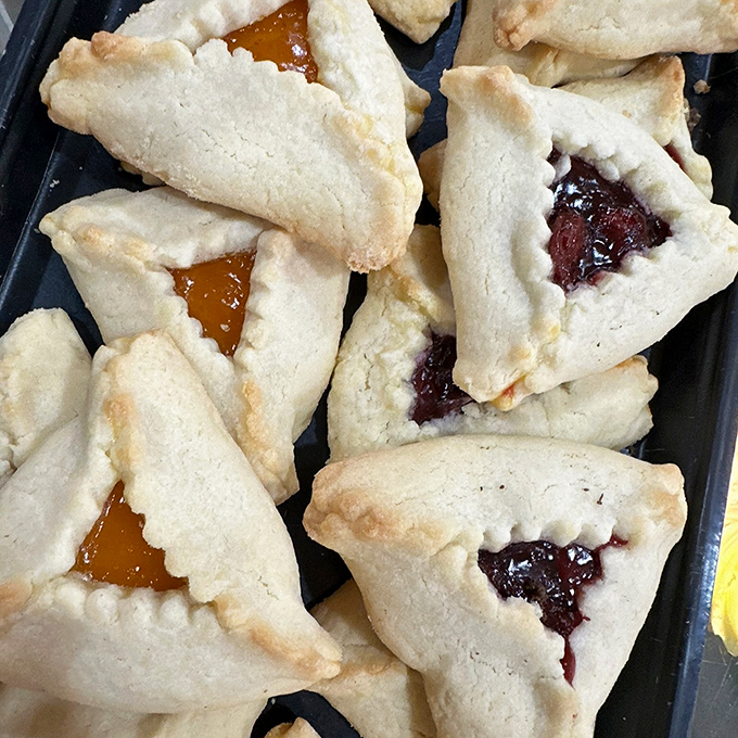 Hamantaschen: Triangle-shaped pockets of joy revealing their fruity secrets &ndash; like edible origami filled with sunshine and childhood memories.
