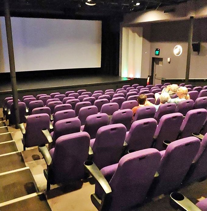 Plush purple seats await in one of the Tropic's screening rooms, promising comfort that matches the quality of the programming.