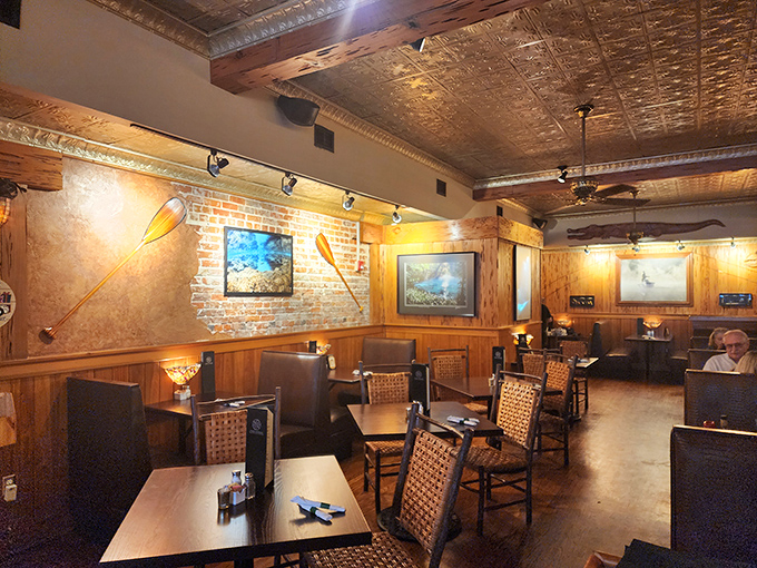 Pressed tin ceilings and wooden accents create a rustic elegance that perfectly complements the restaurant's connection to Florida's natural beauty.