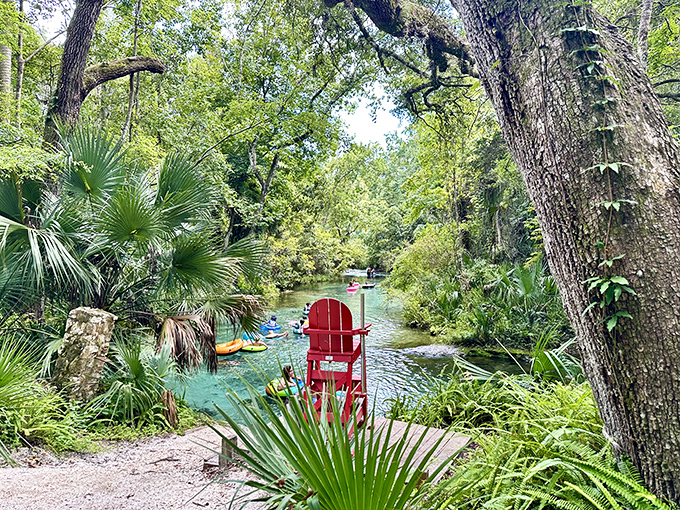 The iconic red lifeguard chair stands sentinel over paradise. It's reassuring to know someone's watching, even when you're just drifting along at nature's pace.
