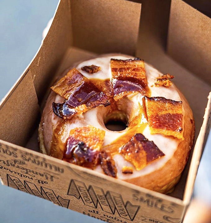 Maple Bacon Donut: Sweet meets savory in perfect harmony &ndash; those crispy bacon pieces are the jewelry adorning this maple-glazed masterpiece.