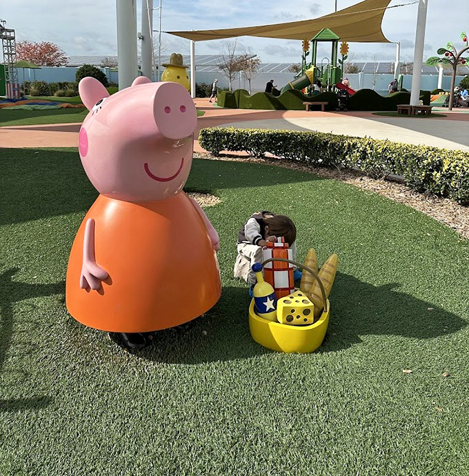Mummy Pig stands proudly in the sunshine – a fiberglass ambassador welcoming little ones to this porcine paradise of childhood joy.
