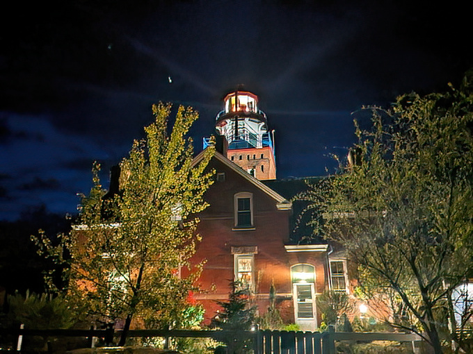 By night, the lighthouse transforms into a magical beacon, its light cutting through darkness like a celestial lighthouse keeper's flashlight.