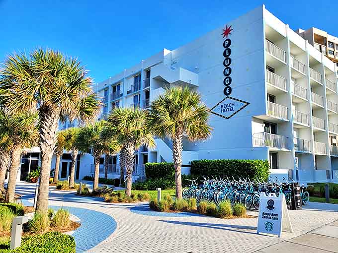 Plunge Beach Resort's crisp white fa&ccedil;ade pops against the blue sky, with palm sentinels standing guard and bicycles waiting for adventure.