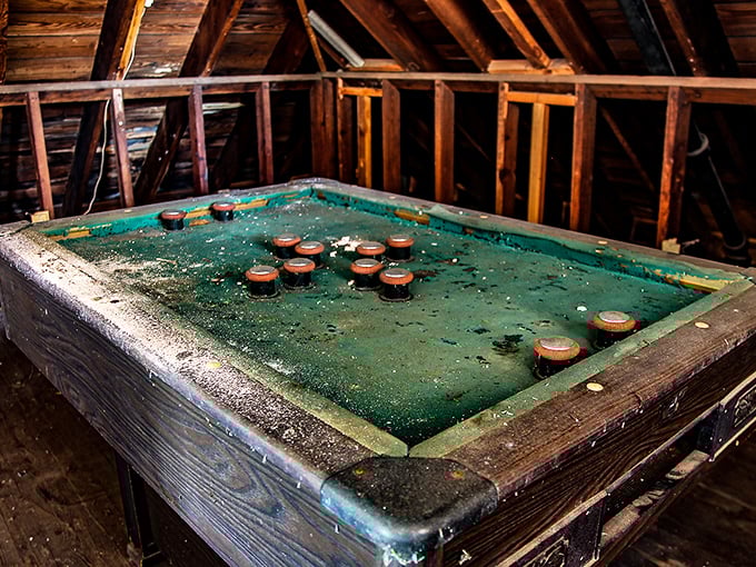 This forgotten game table has witnessed countless matches and friendly wagers, its green surface now playing host to dust and memories.