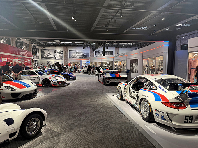 These race cars sit in formation like they're waiting for the green flag, their competition days behind them but their glory still shining bright.