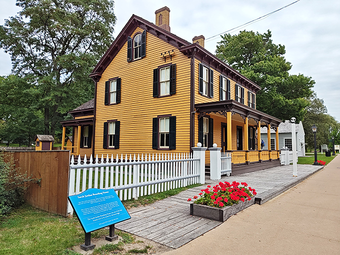 The Sarah Jordan Boarding House stands proudly in mustard yellow, representing an early chapter in women's professional independence.
