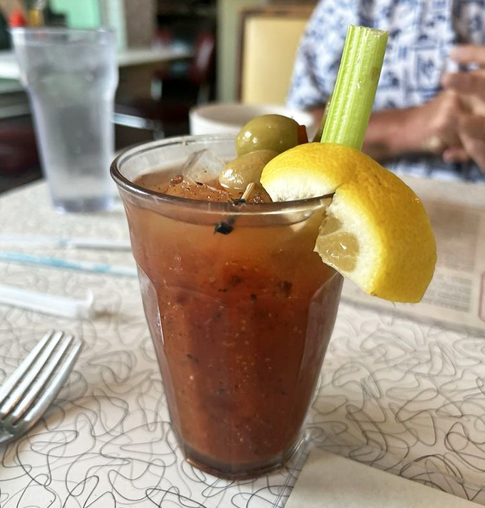 Morning salvation in a glass, garnished with the holy trinity of hangover cures: celery, olives, and lemon.