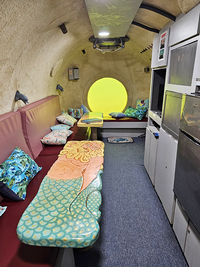 Interior view showcasing the surprisingly homey underwater living space &ndash; complete with mermaid-approved cushions and ocean-themed decor.
