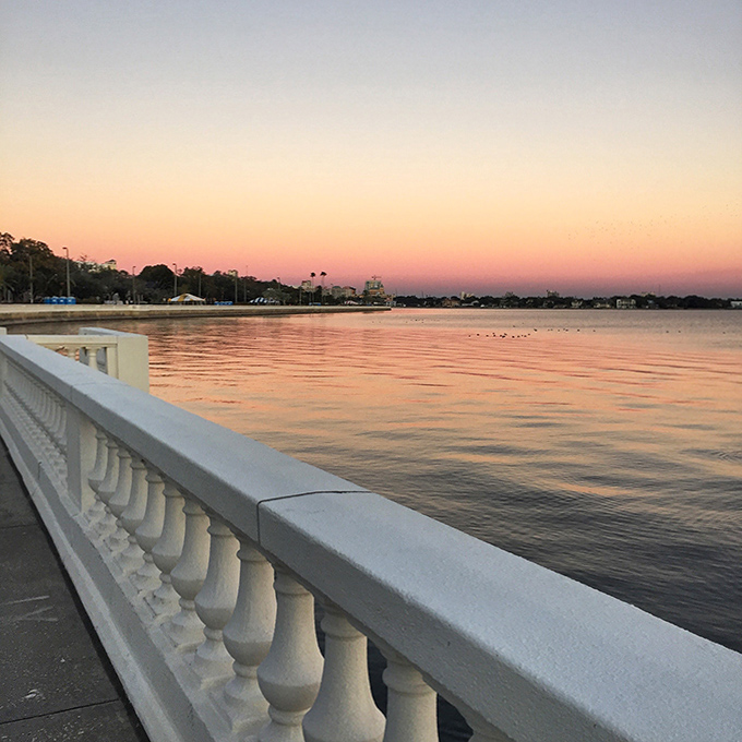 Sunset paints Hillsborough Bay in watercolor hues, transforming Tampa's everyday sidewalk into a pathway through living art.