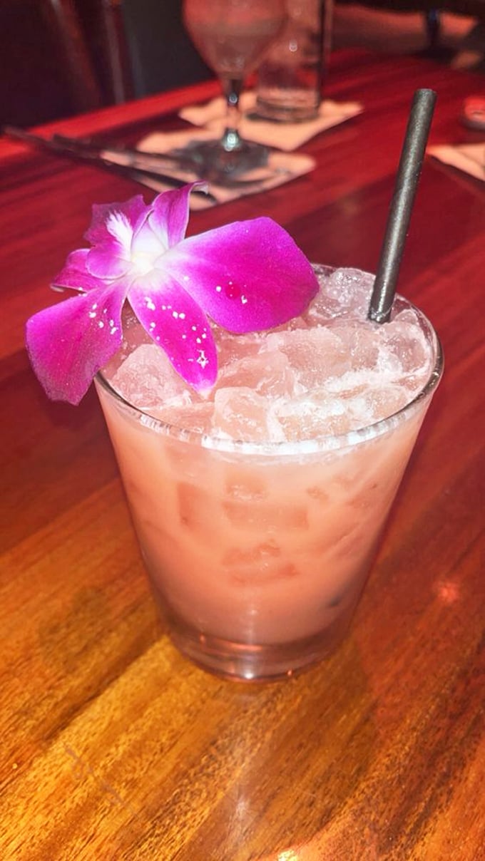 This Tahitian Paradise cocktail, garnished with a fresh orchid, makes your usual happy hour order look like it's not even trying to impress anyone.