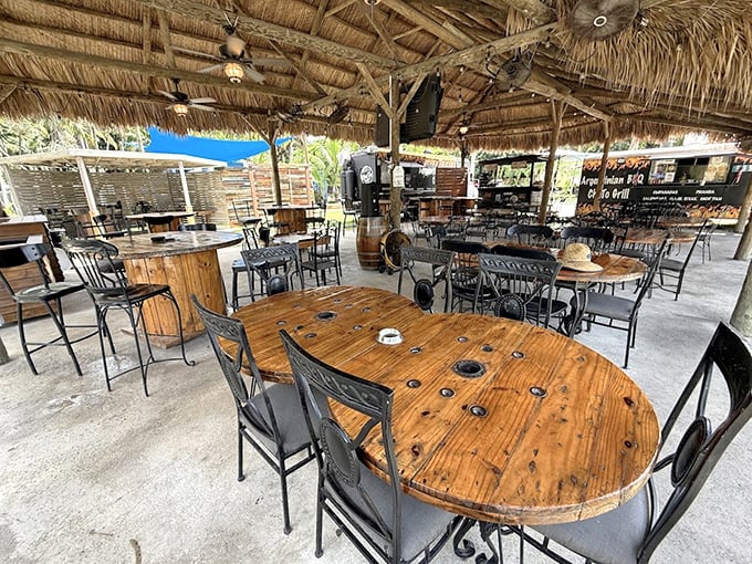 Rustic elegance defines the dining area, where wooden tables under thatched roofs create the perfect post-swim refueling station.