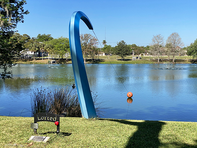 The sculptural blue fishing rod at Tuscawilla Park celebrates Florida's favorite pastime while fountains dance across the serene lake.
