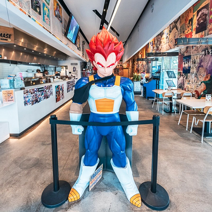 The Vegeta statue stands guard like he's personally ensuring your meal meets the high standards of a Saiyan prince.