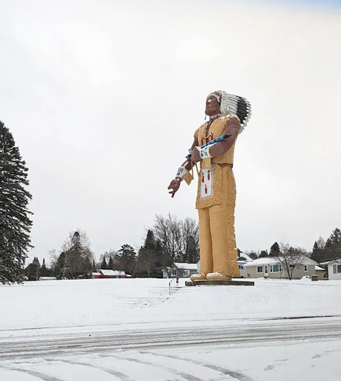 Even in winter, Hiawatha stands sentinel through Michigan's legendary snowfalls, his golden form creating a striking contrast against the white landscape.