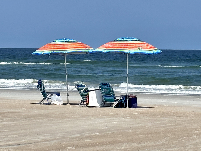 Beach chairs and umbrellas create a perfect basecamp for a day of coastal exploration &ndash; civilization's comfortable outpost on wilderness shores.