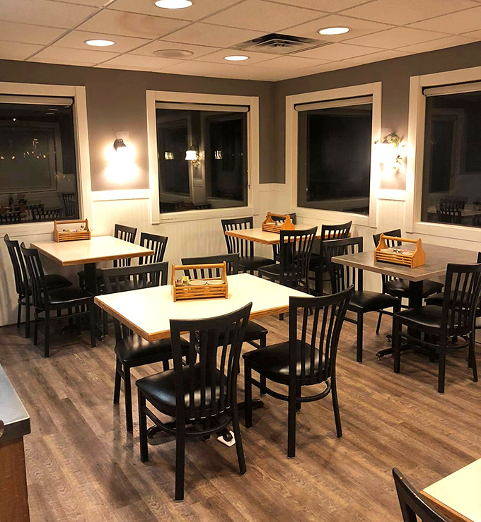 Evening transforms the dining area into a cozy retreat, where warm lighting invites lingering conversations over coffee and dessert.