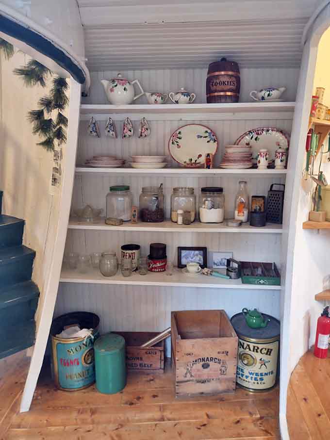 Vintage dishware and tea sets create a charming display that would make any grandmother proud, barrel-shaped house or not.