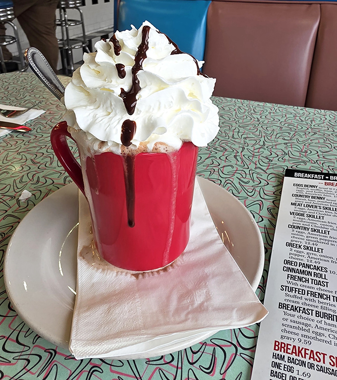 Hot chocolate elevated to an art form &ndash; a red mug overflowing with whipped cream and chocolate drizzle that's worth every calorie.