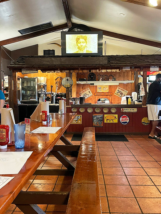 The counter service area showcases decades of barbecue heritage, with vintage signs and the constant choreography of servers delivering platters of smoky goodness.