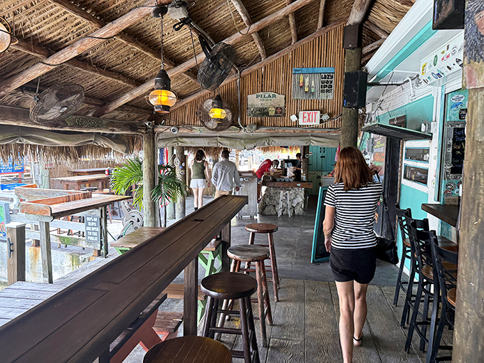 The dining room's rustic charm comes from decades of authentic Keys living, not from a designer's "coastal aesthetic" Pinterest board.