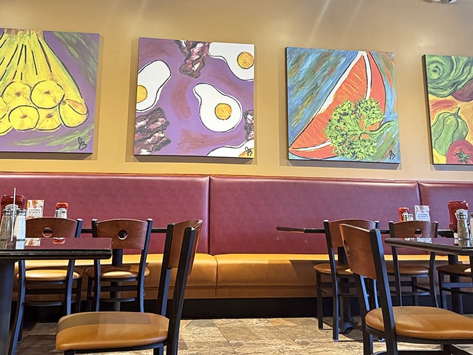 Vibrant food-themed artwork adds personality to the warm interior, making even waiting for your pancakes a visually pleasing experience.