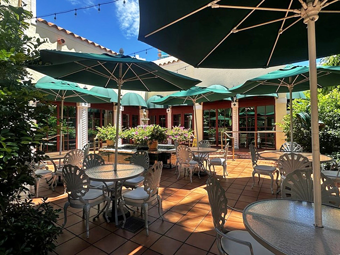 The charming terrace offers al fresco dining under green umbrellas, creating a Mediterranean-inspired oasis perfect for people-watching while enjoying Joe's legendary cuisine.
