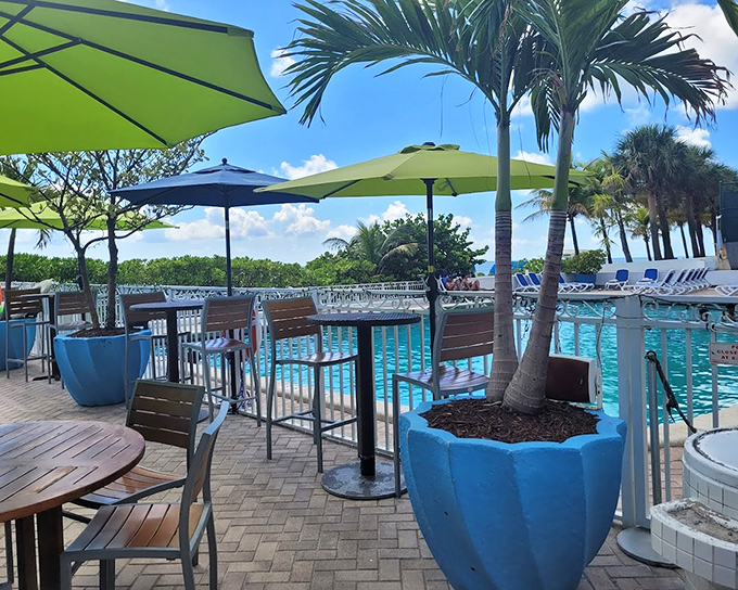 The pool area offers a refreshing alternative when the ocean seems too adventurous, with palm trees standing guard like tropical sentinels.