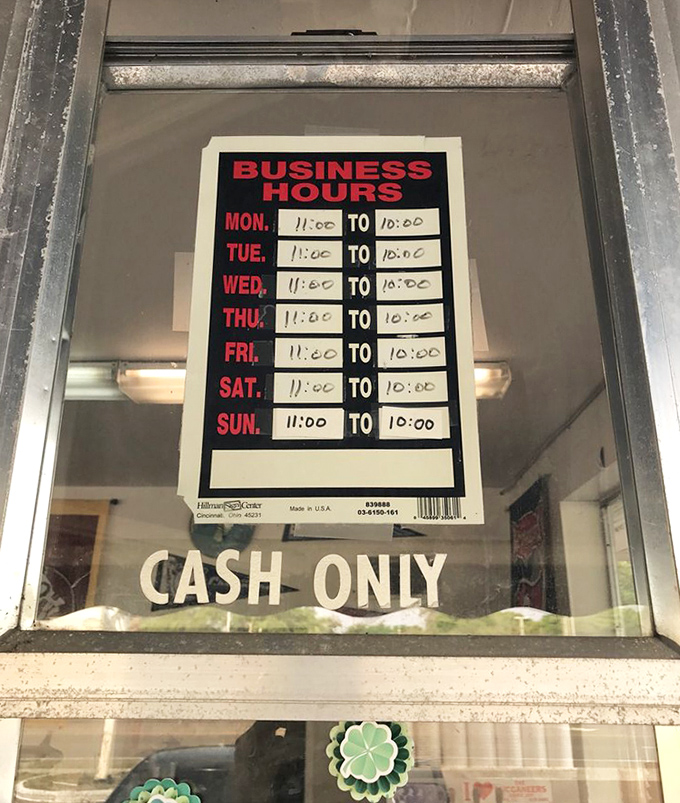The business hours sign might as well read "Open when you need ice cream" and "Closed when you should be sleeping"—with a gentle reminder that cash is king.