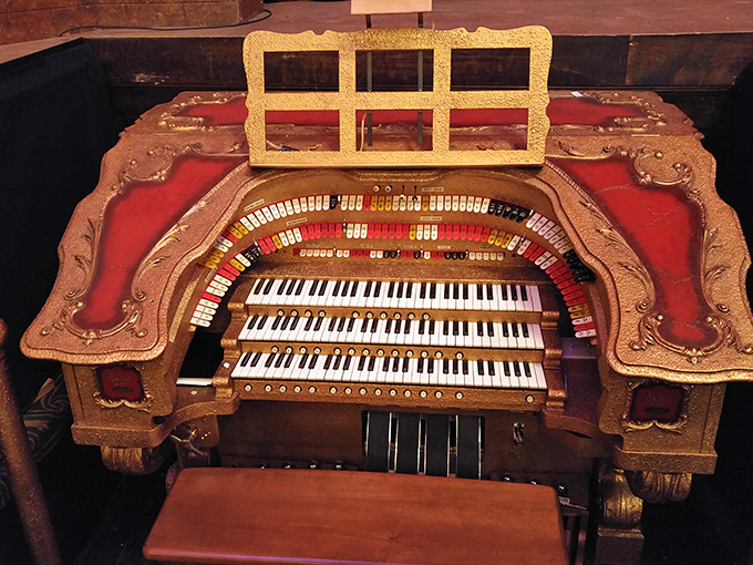 The Barton Theater Pipe Organ console sits ready for performance, its keys waiting to unleash musical magic from thousands of hidden pipes.