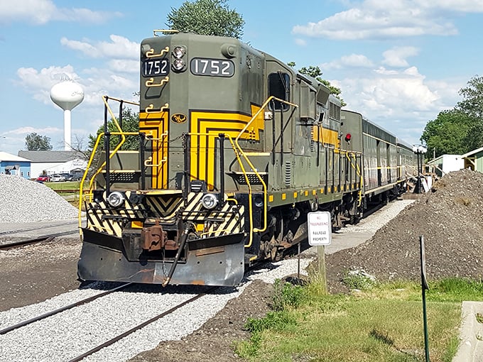 Engine 1752 stands ready for departure, its green and yellow livery gleaming in the sunlight like evidence waiting to be discovered.