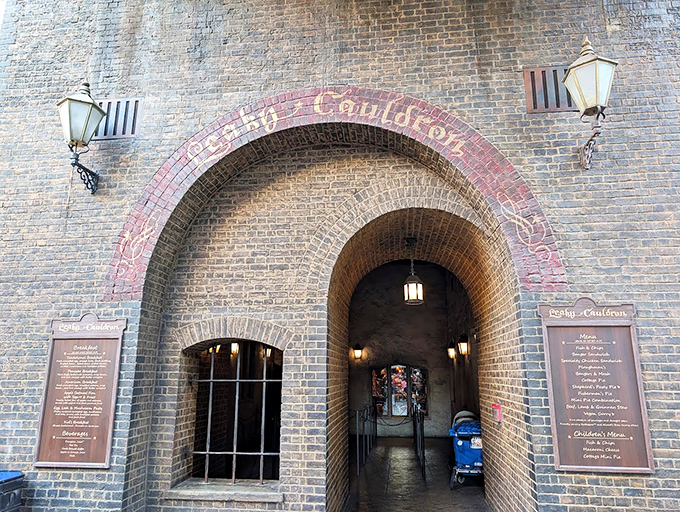 The Leaky Cauldron's weathered brick facade and medieval signage transport visitors to another world. This unassuming entrance hides magical dining experiences inside.