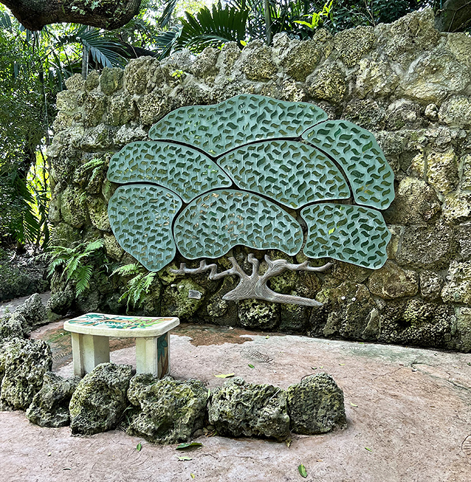 Metal tree art emerges from ancient stone, its stylized branches reaching skyward in a perfect blend of natural inspiration and artistic interpretation.