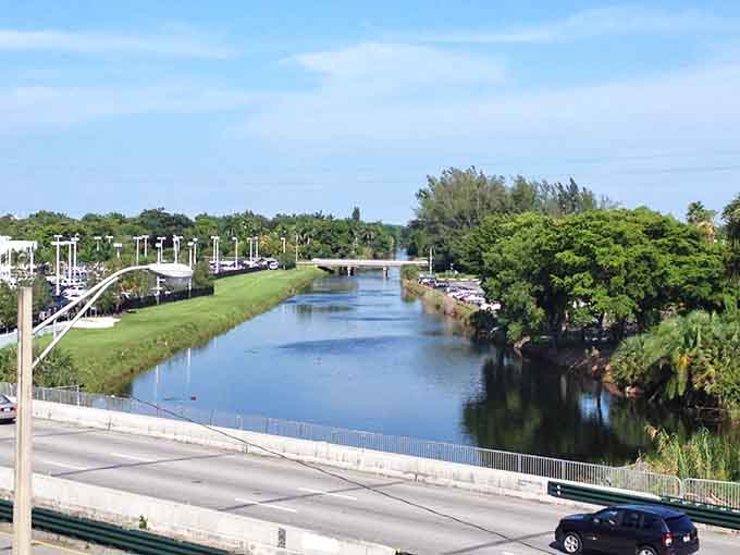 The canal runs calm and clear, reflecting the sky above while keeping its mysterious reputation carefully hidden below the surface.
