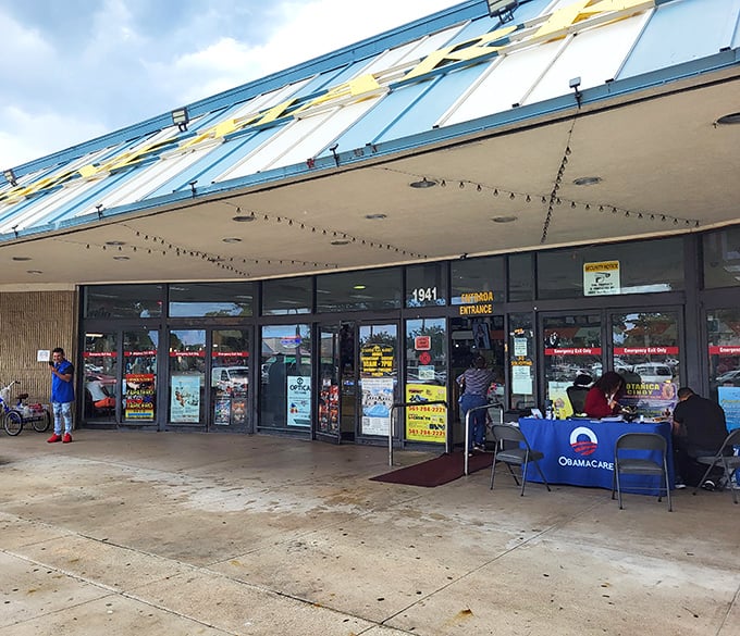 Democracy in action&mdash;shopping and healthcare! Sunshine Market's glass entrance welcomes all, while an Obamacare information table reminds us flea markets are community hubs.