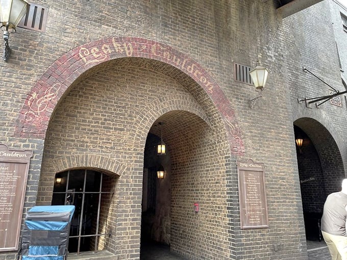 Ancient brick archways and vintage lanterns create an authentic old-world pub atmosphere. You can almost imagine centuries of magical patrons passing through this doorway.