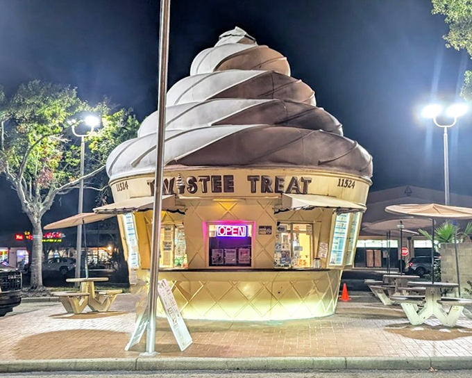 This whimsical cone-shaped structure glows like a dessert lighthouse against the evening sky.