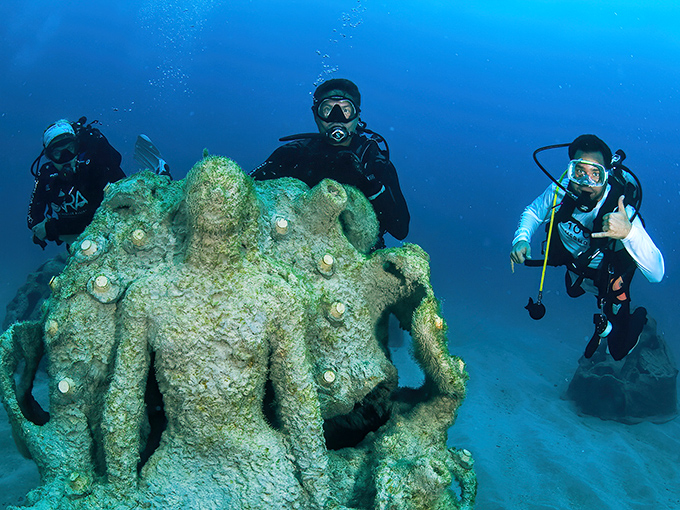 Beachgoers encounter a preview of the underwater magic at this shoreline display promoting ocean conservation through art.