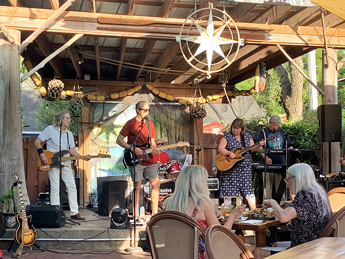 Local musicians transform the outdoor patio into a concert venue, their melodies drifting through the evening air as diners tap along.