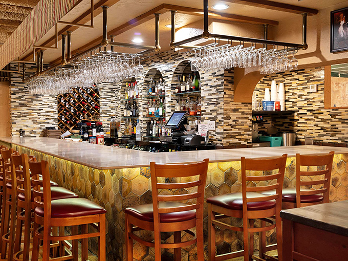 The modern bar area balances tradition with contemporary touches, offering a perfect perch for solo diners or pre-dinner drinks.