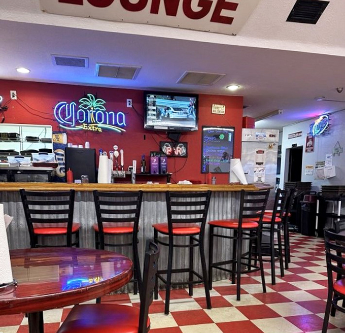 The bar area strikes that perfect balance between dive bar authenticity and welcoming accessibility, with neon signs casting a warm glow.