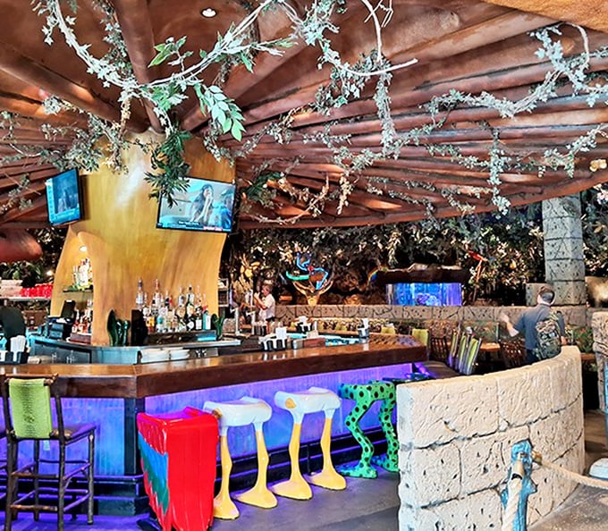 The bar area offers adult beverages with whimsical presentation, perfect for those seeking a more sophisticated jungle experience.