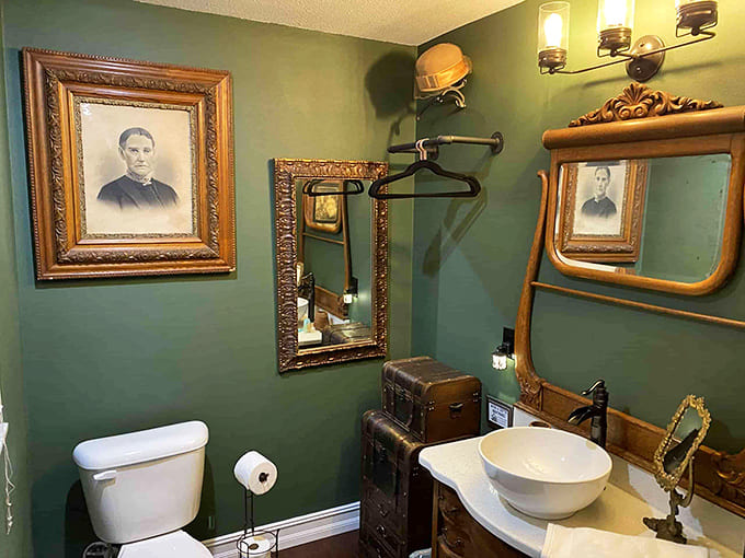 Even the bathroom embraces the theme with vintage portraits watching over you. Privacy is a relative concept in a house with this many "faces."