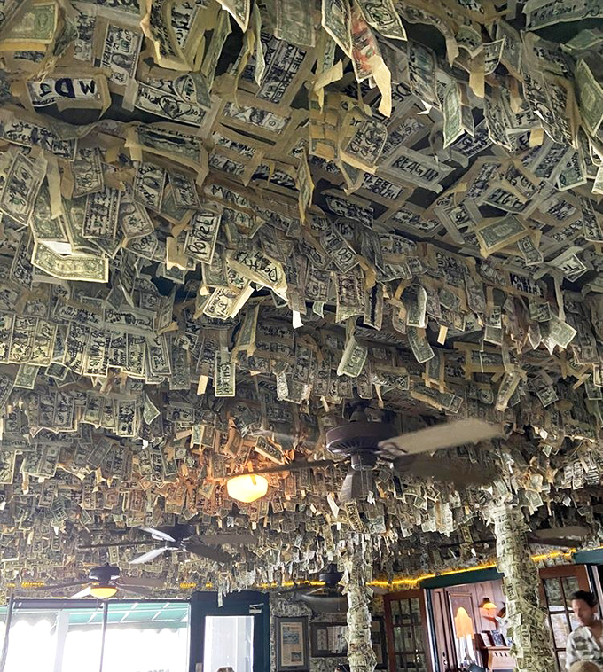 Look up! The ceiling fan spins gently beneath a canopy of cash, creating a fluttering effect as dollars dance in the breeze.