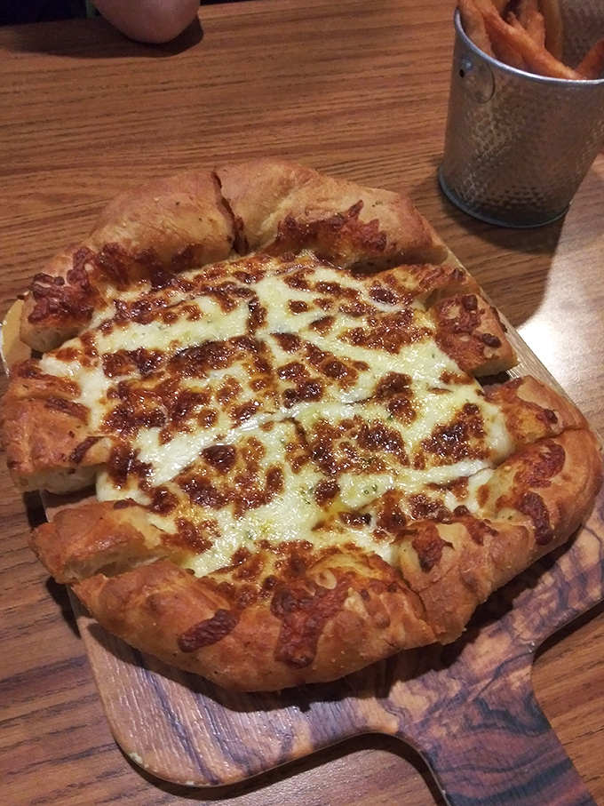 This isn't just cheese bread &ndash; it's a carb-loaded masterpiece with a perfectly crispy crust that justifies every lap in the lazy river.