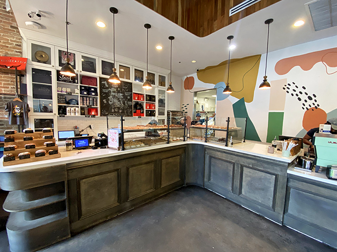Counter: Command central where donut dreams become reality &ndash; the gleaming display case showcases today's edible artwork.