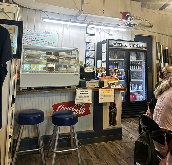 The counter area with its Coca-Cola stools invites solo diners to perch and chat while watching the rhythmic dance of the kitchen staff.