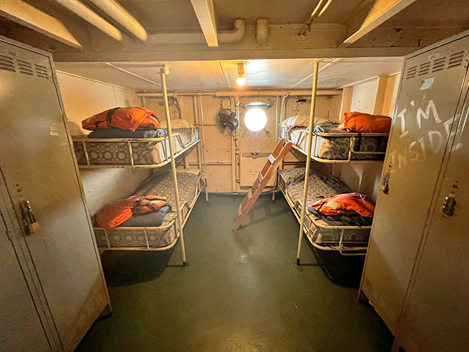 The cramped crew quarters with stacked bunks show the tight quarters where exhausted sailors snatched precious hours of sleep.