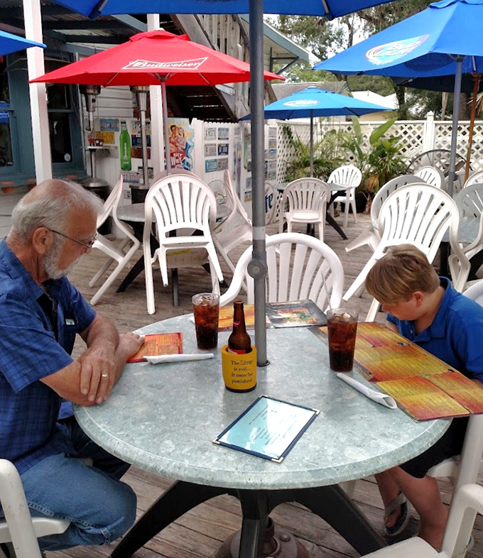 Generations connect over cold drinks and hot food at this outdoor table, where menus are studied with the seriousness of treasure maps.