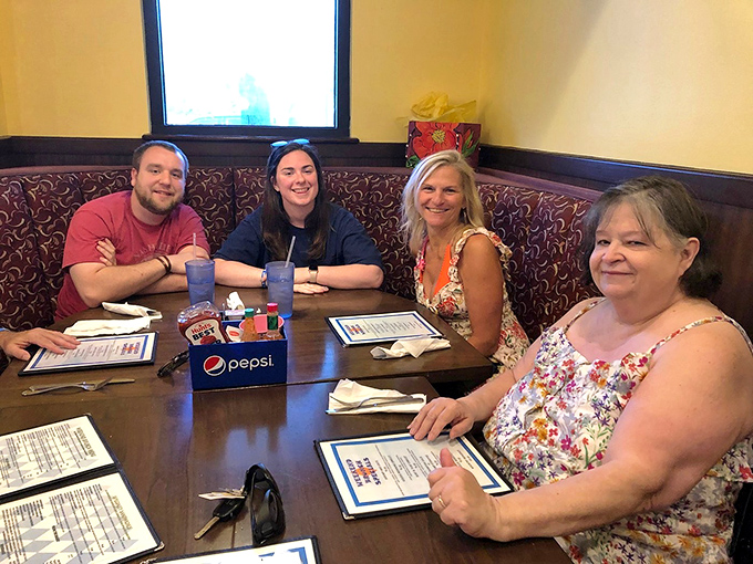 Happy diners gather around the table, menus in hand, ready to embark on a culinary adventure that never disappoints.